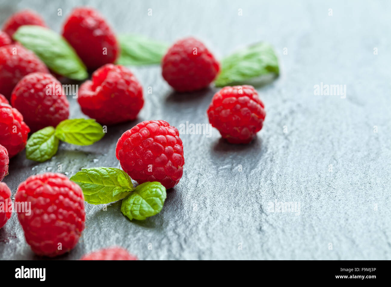 Heap of raspberry on stone Stock Photo - Alamy