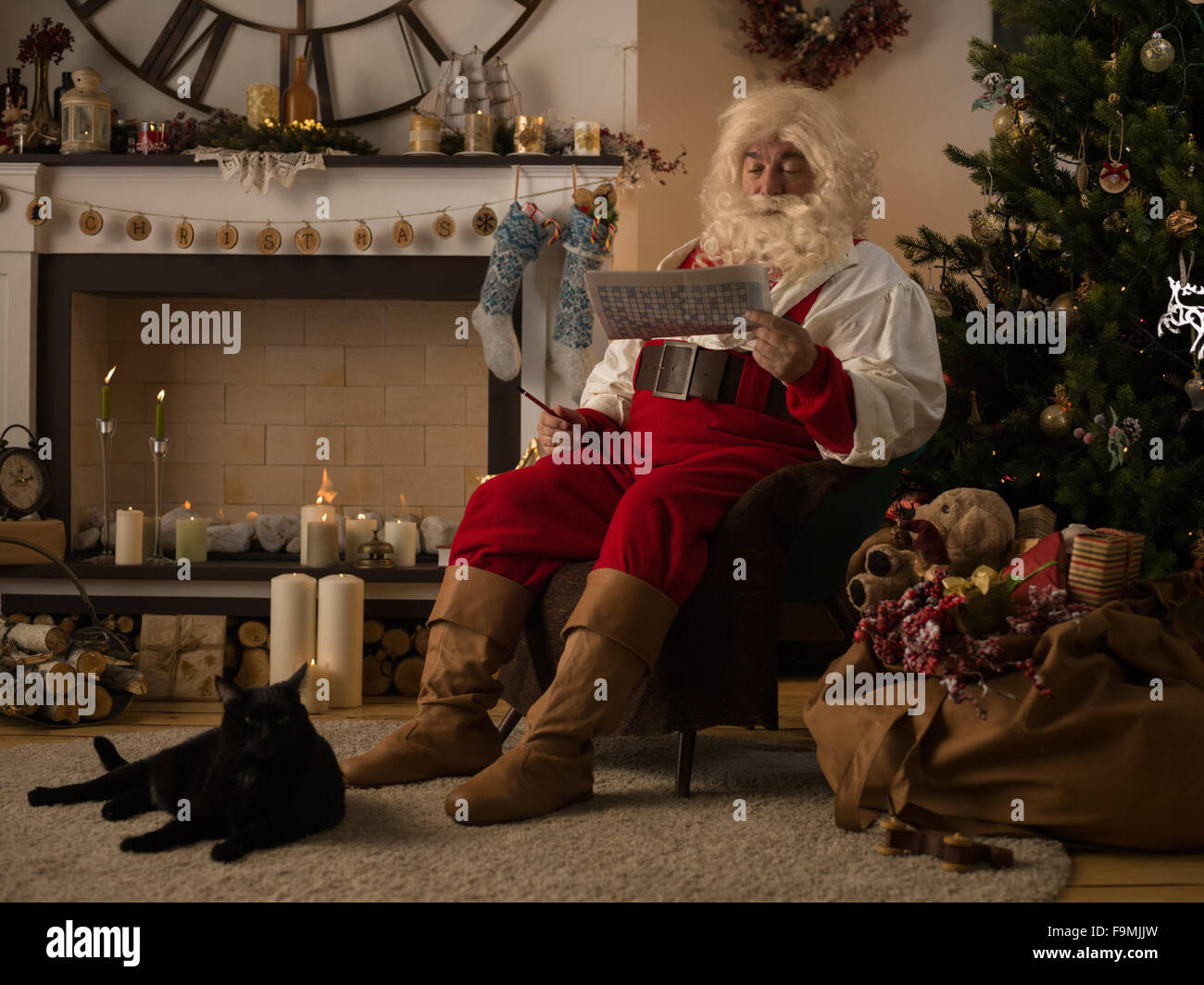 Santa Claus Resting at Home near Christmas Tree Stock Photo - Alamy