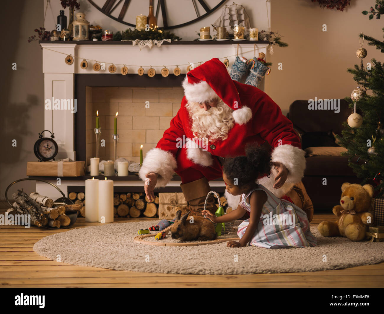 Santa Claus with Child playing at Home Stock Photo - Alamy