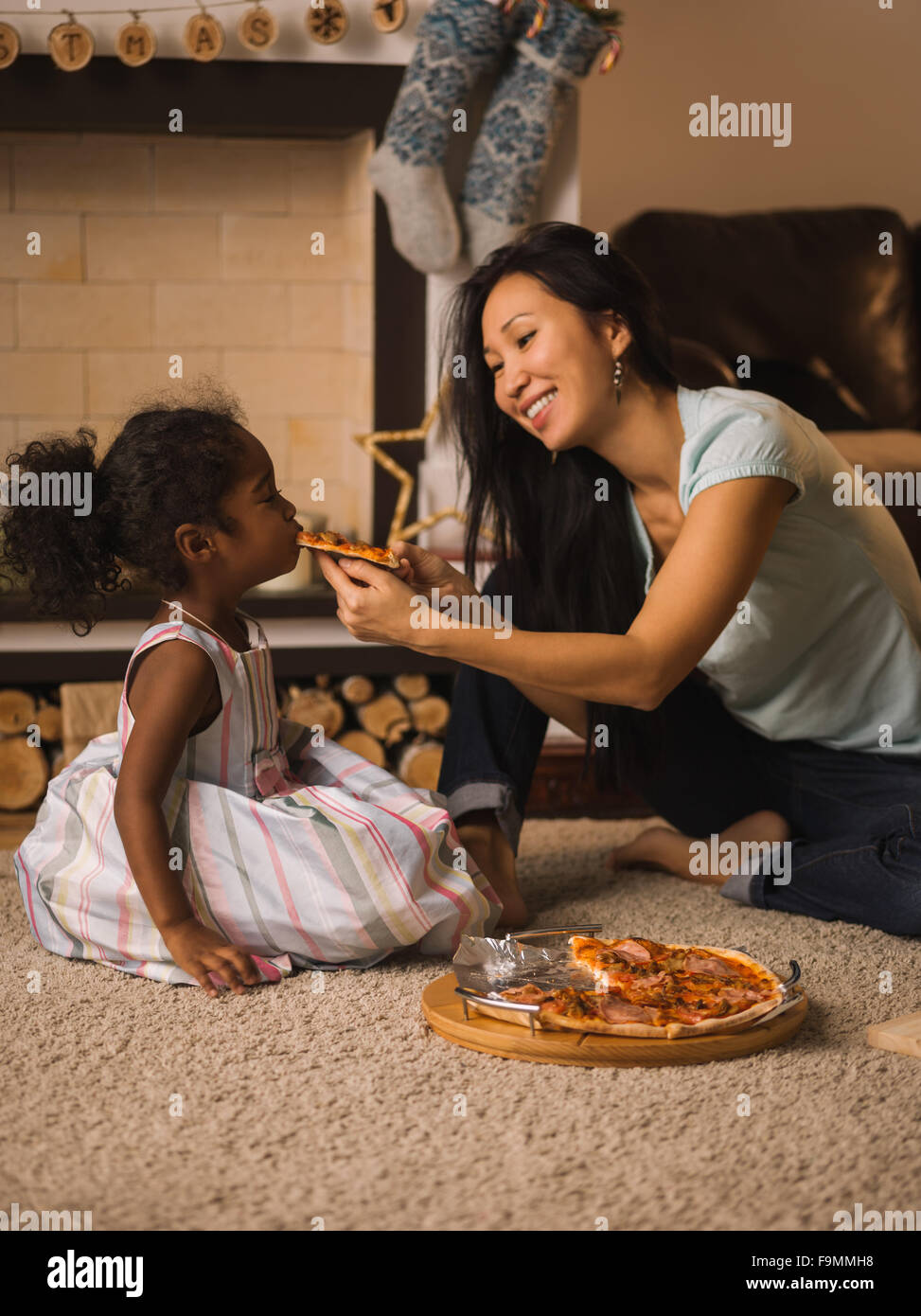 Mother and Daughter eating pizza at home Stock Photo - Alamy
