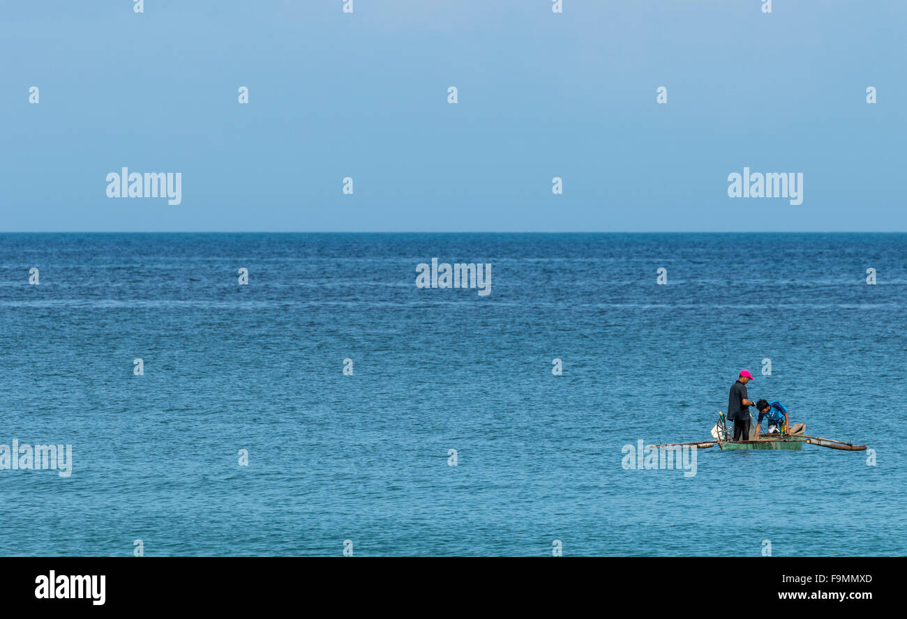 Fishing in traditional boat off Tip of Borneo Beach Sabah East Malaysia ...