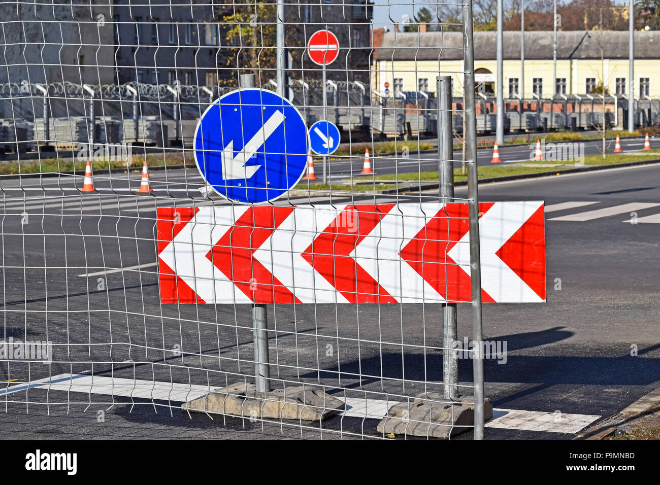 Arrow signs at the closed road crossing Stock Photo - Alamy