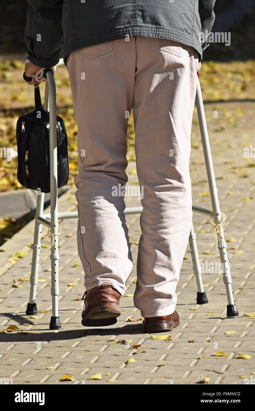Old man walks with a walker Stock Photo - Alamy