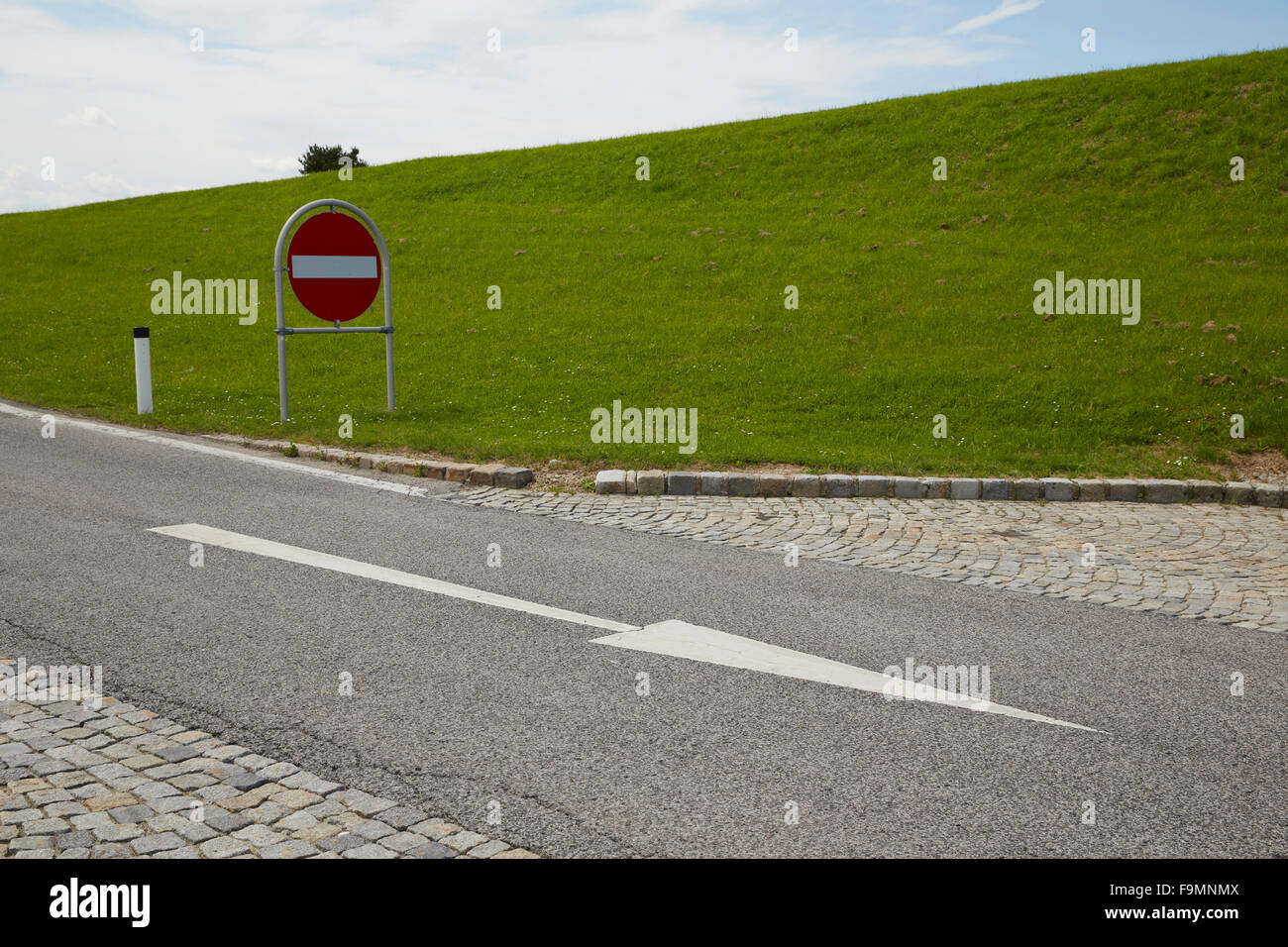 One way road with No Entry road sign and a painted directional arrow ...