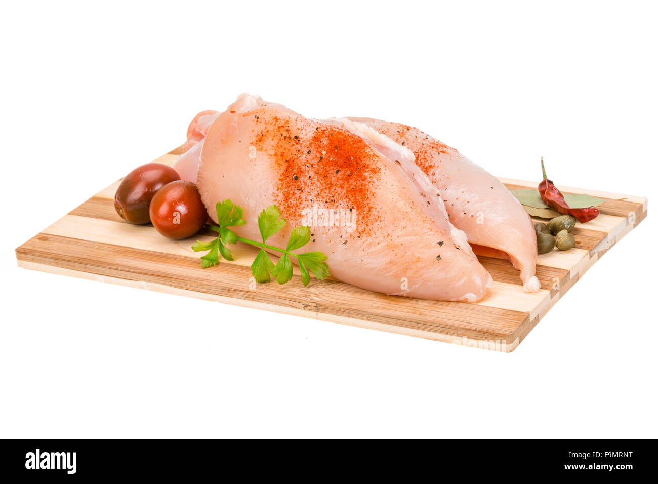 Raw chicken fillet with spices Stock Photo - Alamy