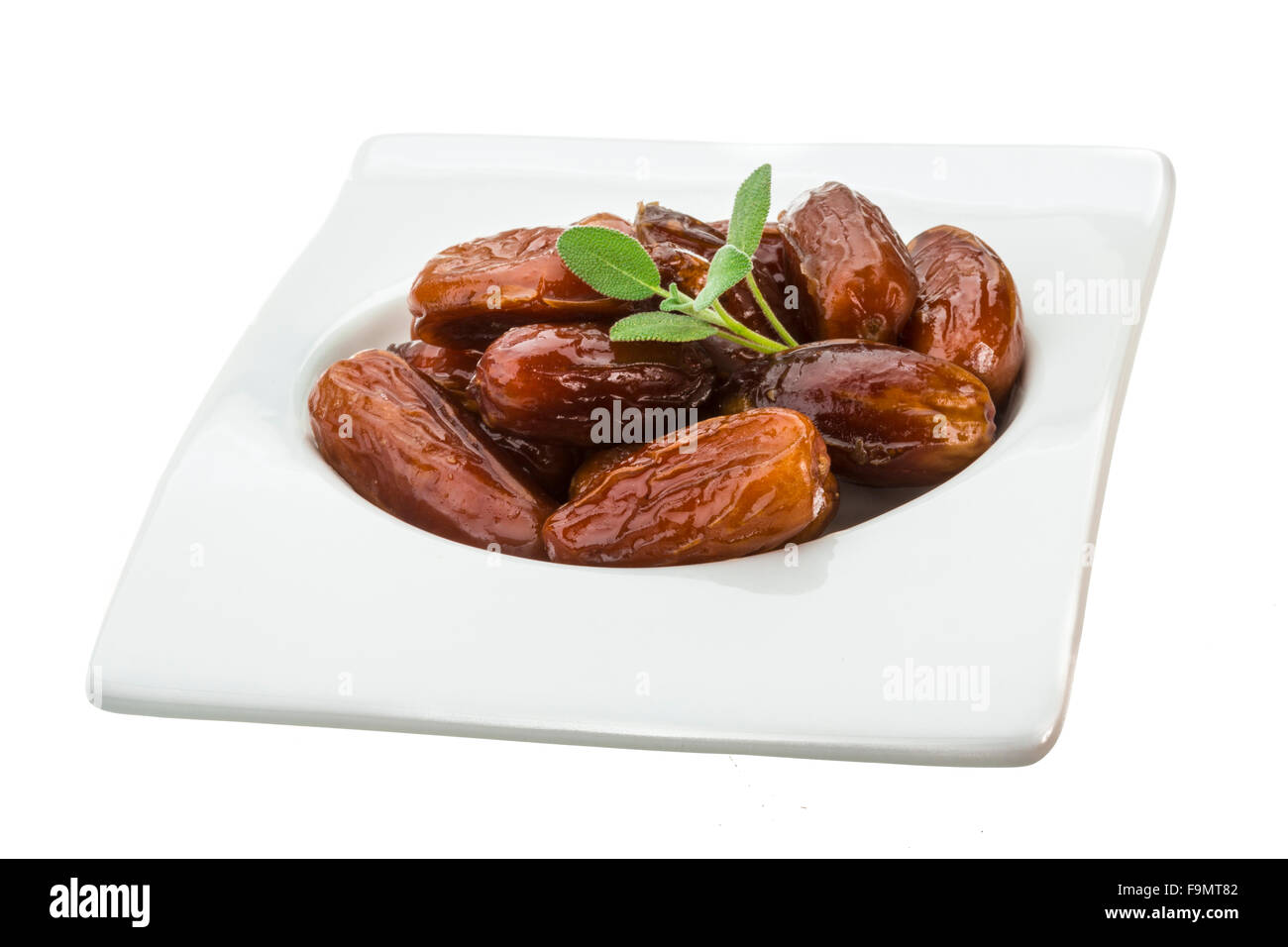 Dates with leaf on the plate Stock Photo - Alamy