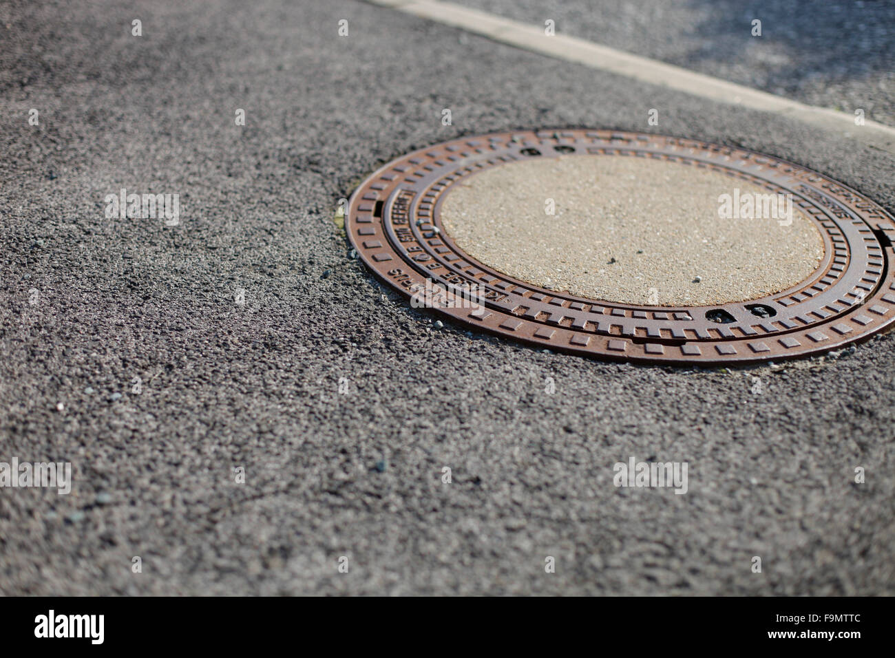 Manhole cover in road hi-res stock photography and images - Alamy
