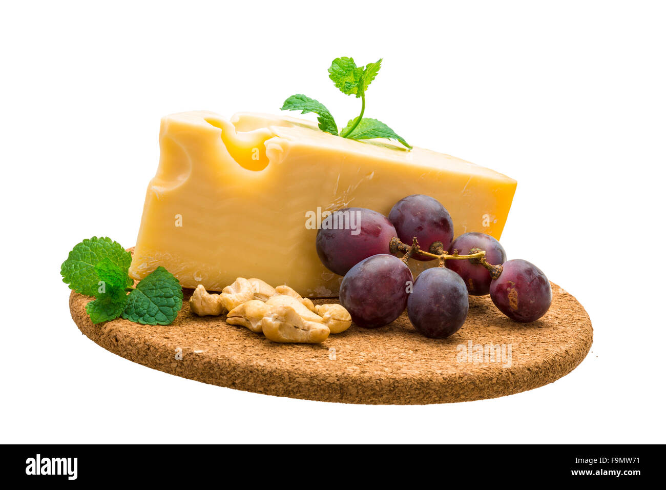 Yellow cheese with grape, mint and nuts Stock Photo - Alamy