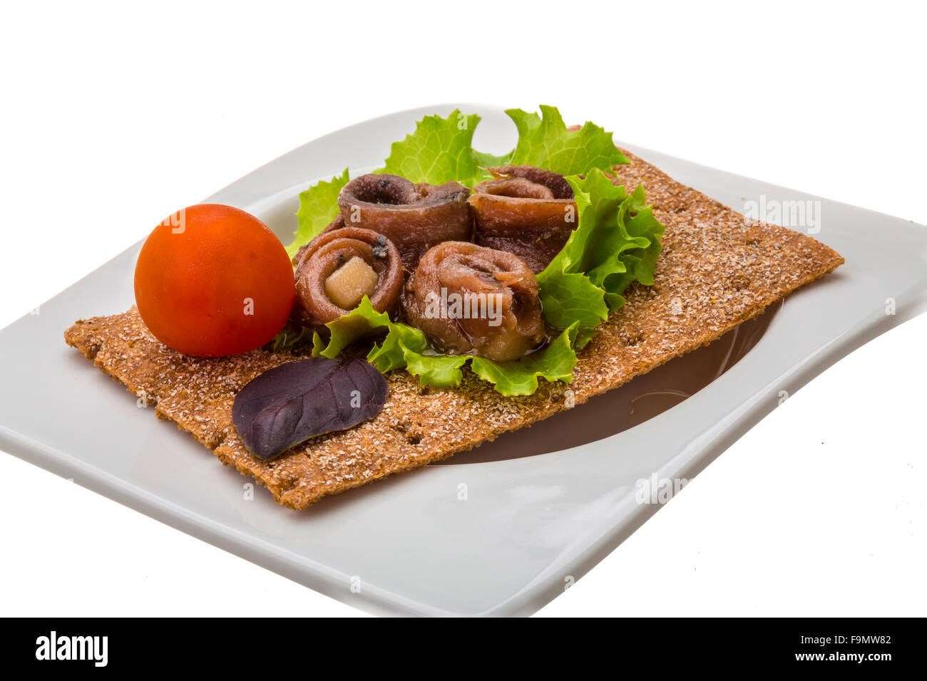 Anchovy snack with salad and tomato Stock Photo - Alamy