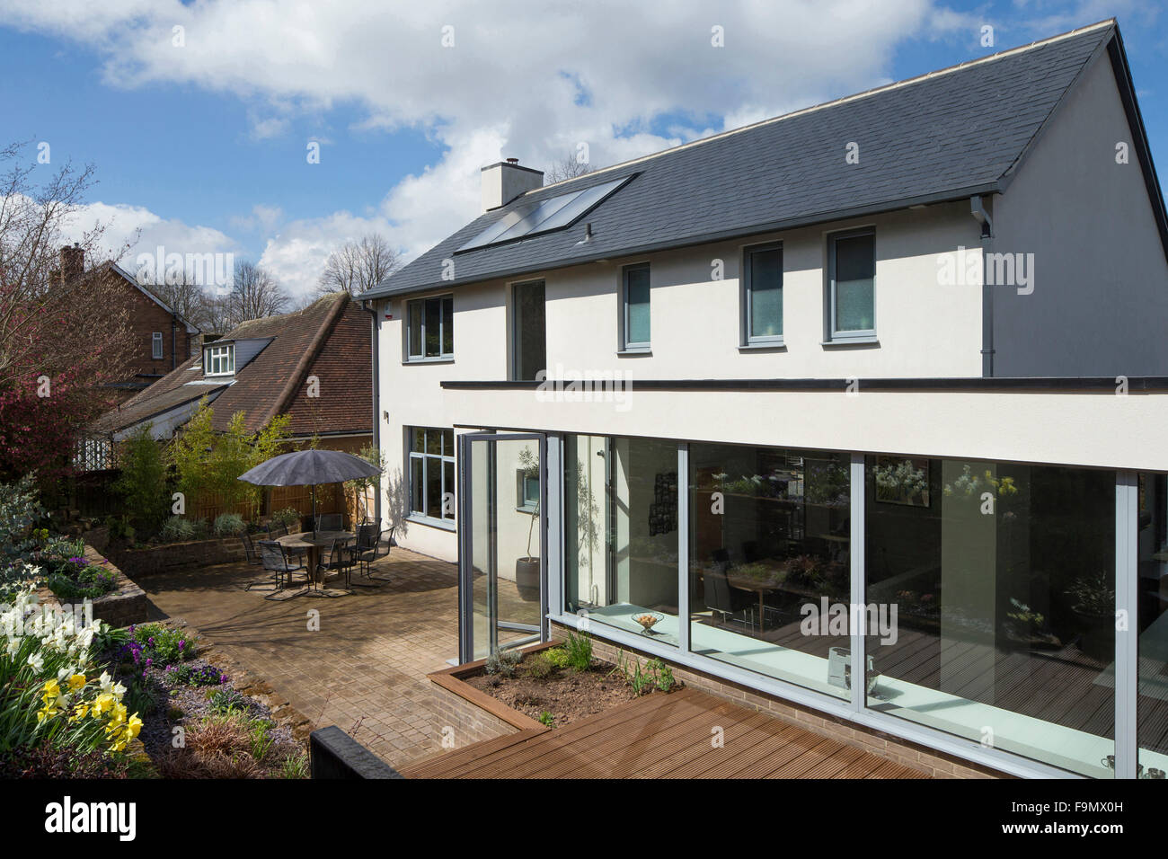 Rear of the house with solar panels and a flat roofed extension with ...