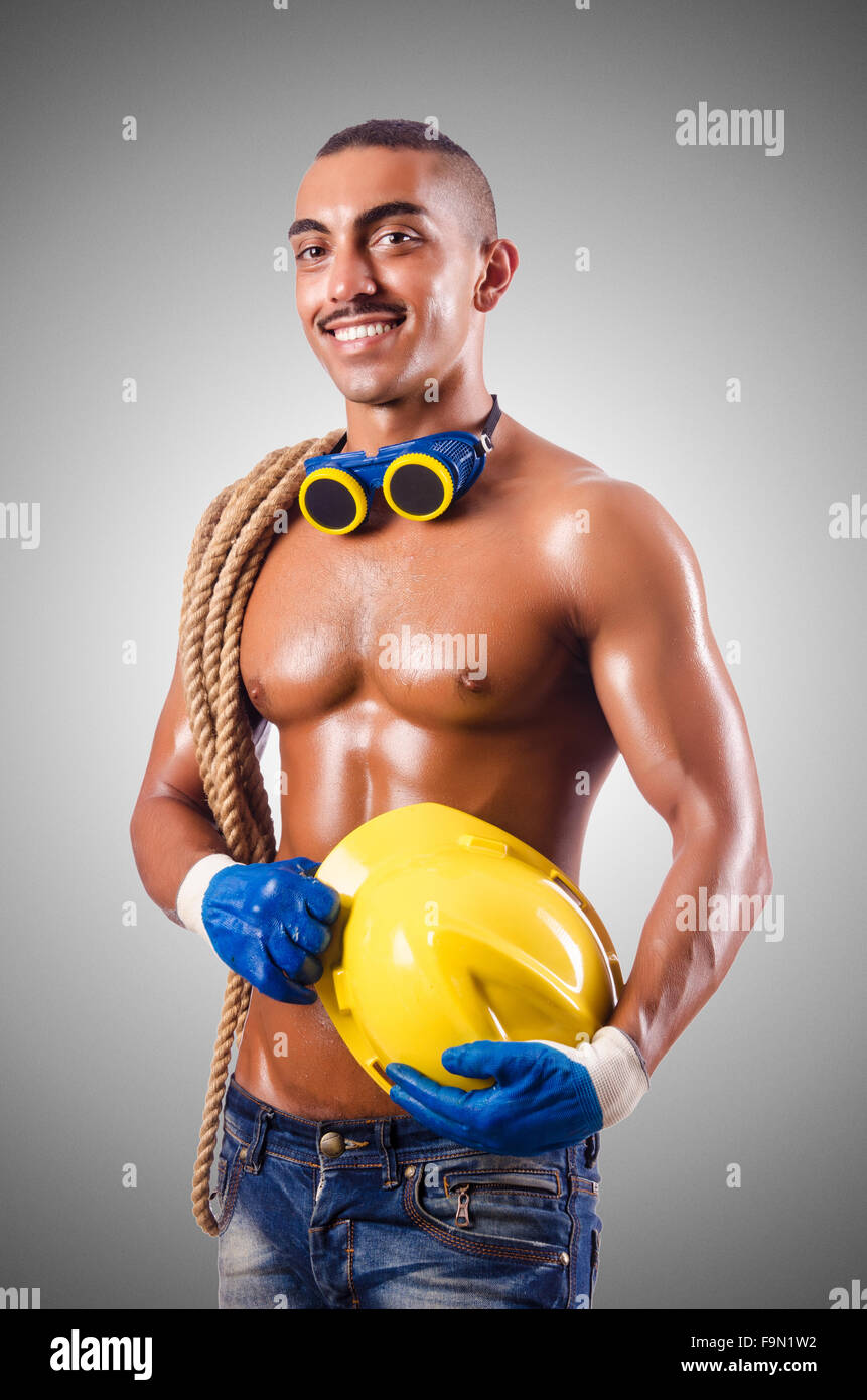 Muscular builder with tools isolated on white Stock Photo - Alamy