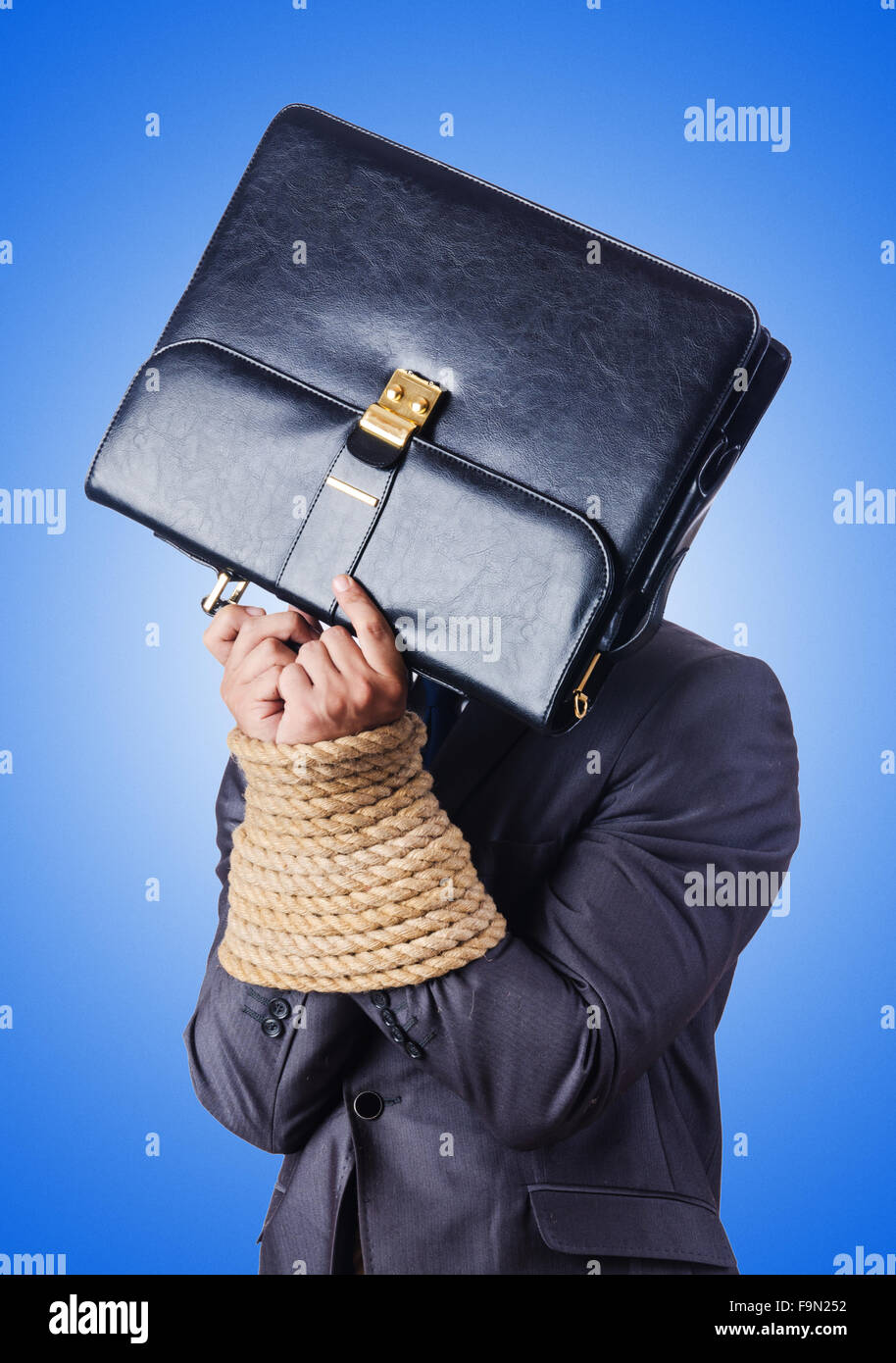 Businessman tied up with rope Stock Photo - Alamy