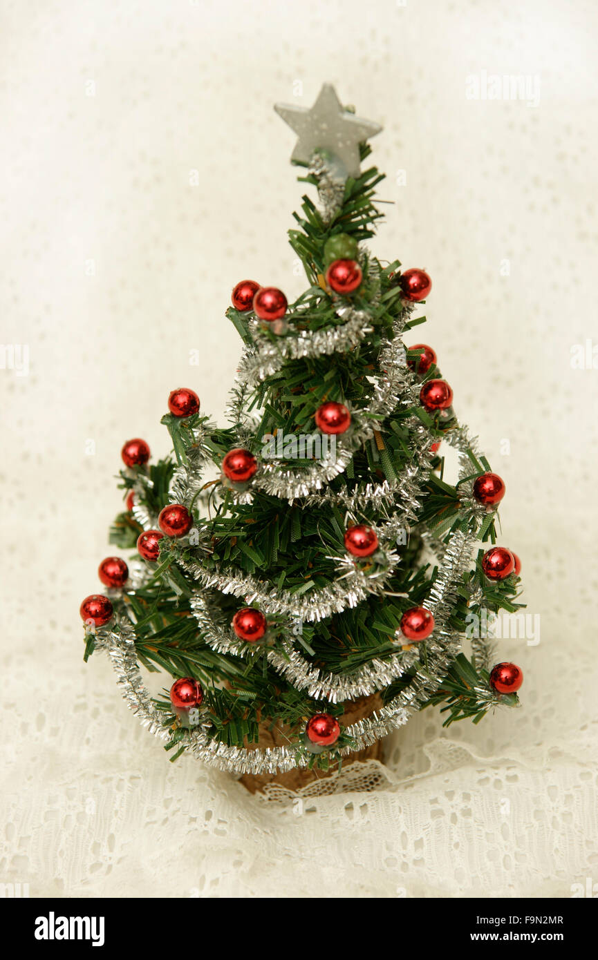 Miniature Christmas tree with a star on a background depicting a snow ...