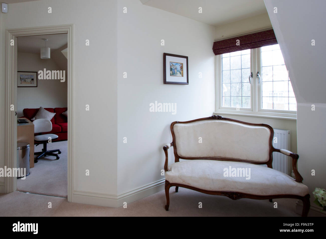 A landing with a chair seat by the window and a doorway Stock Photo - Alamy