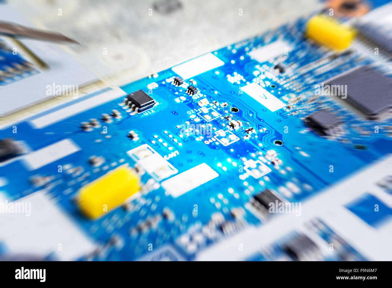Blue electronic circuit board blur close up photography Stock Photo - Alamy