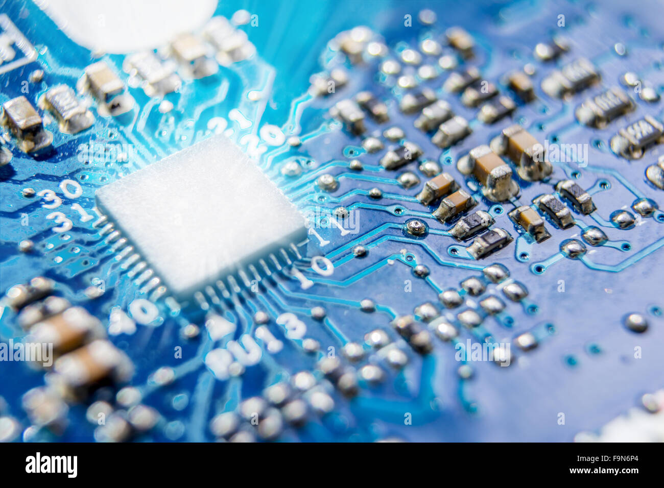 Blue electronic circuit board with glow close up Stock Photo - Alamy