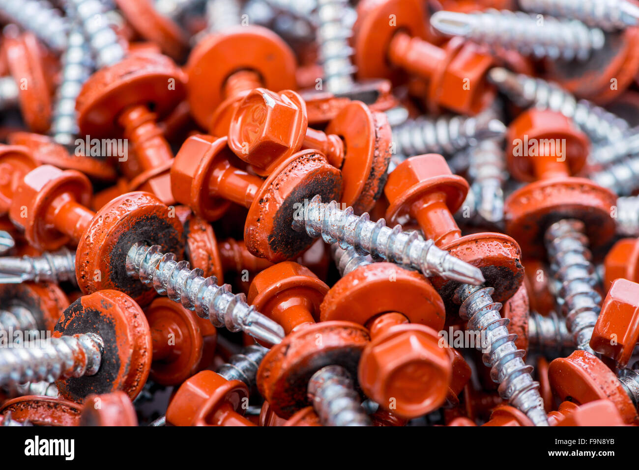 Many screws arranged as background Stock Photo - Alamy