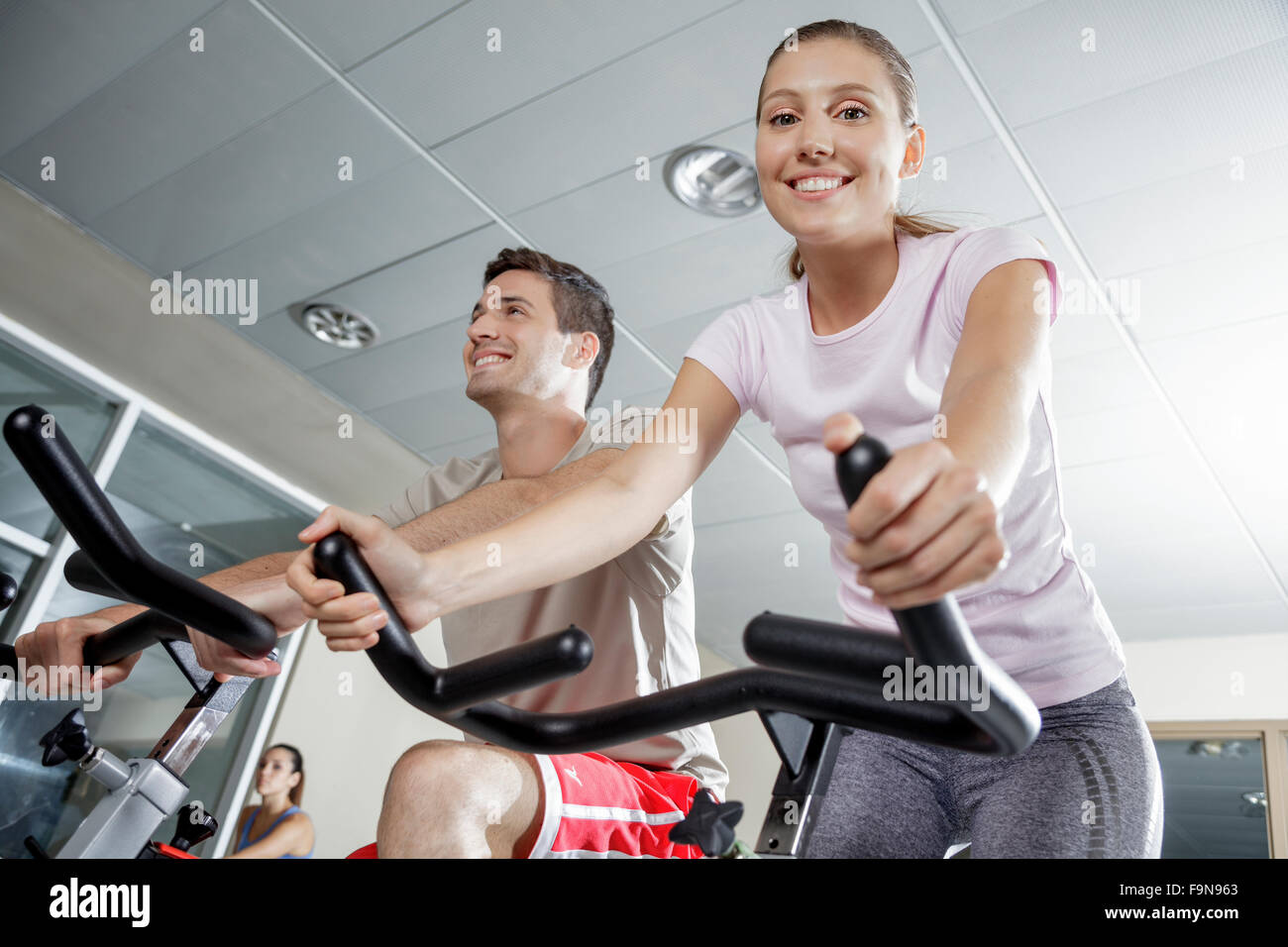 Exercising with bicycles in a gym Stock Photo - Alamy