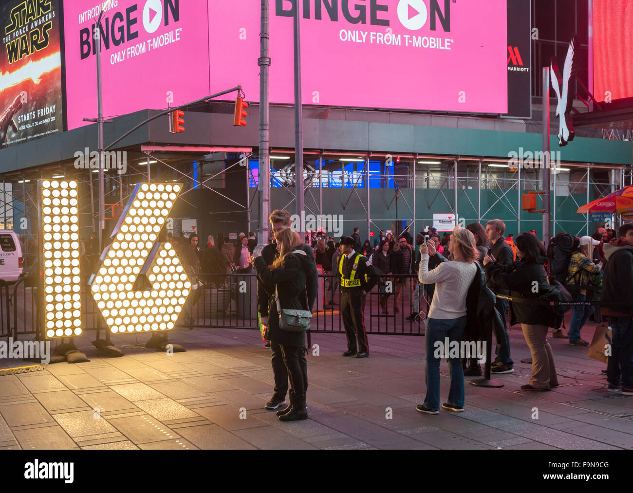 Visitors to Times Square in New York pose in front of the two seven ...