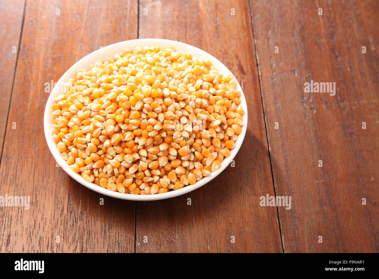 yellow corn grits in the white plate Stock Photo - Alamy