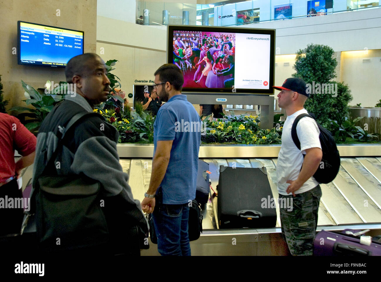 A painting by Archibald John Motley Jr. appears on a digital ...