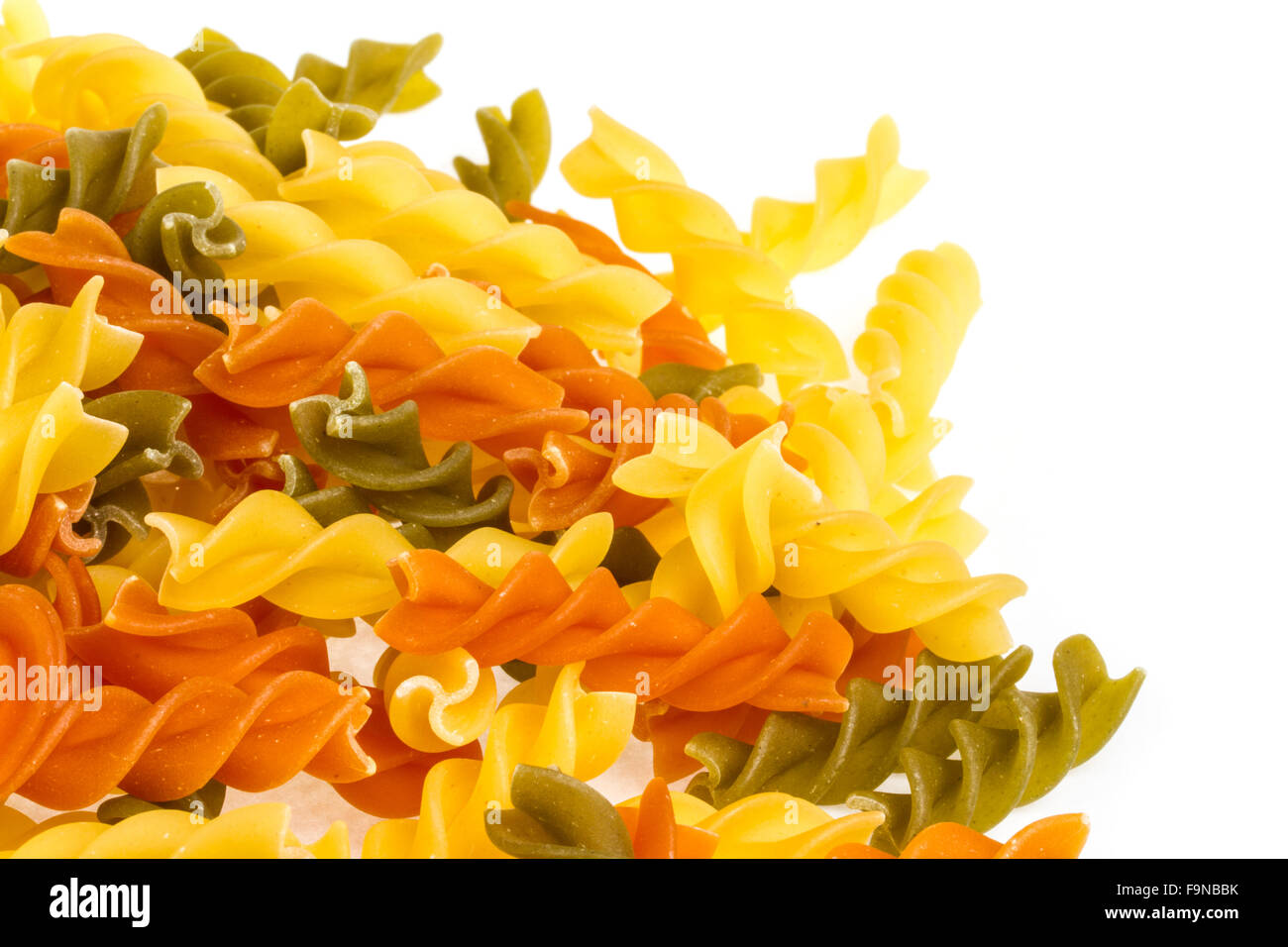 Uncooked pasta fusilli in different colours, white background Stock ...