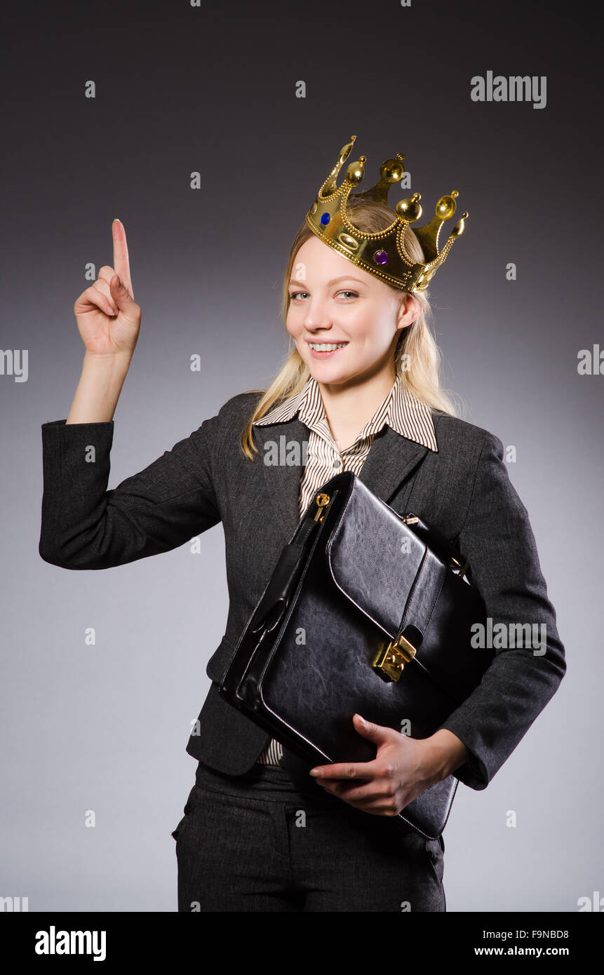 Businesslady wearing crown against gray Stock Photo - Alamy