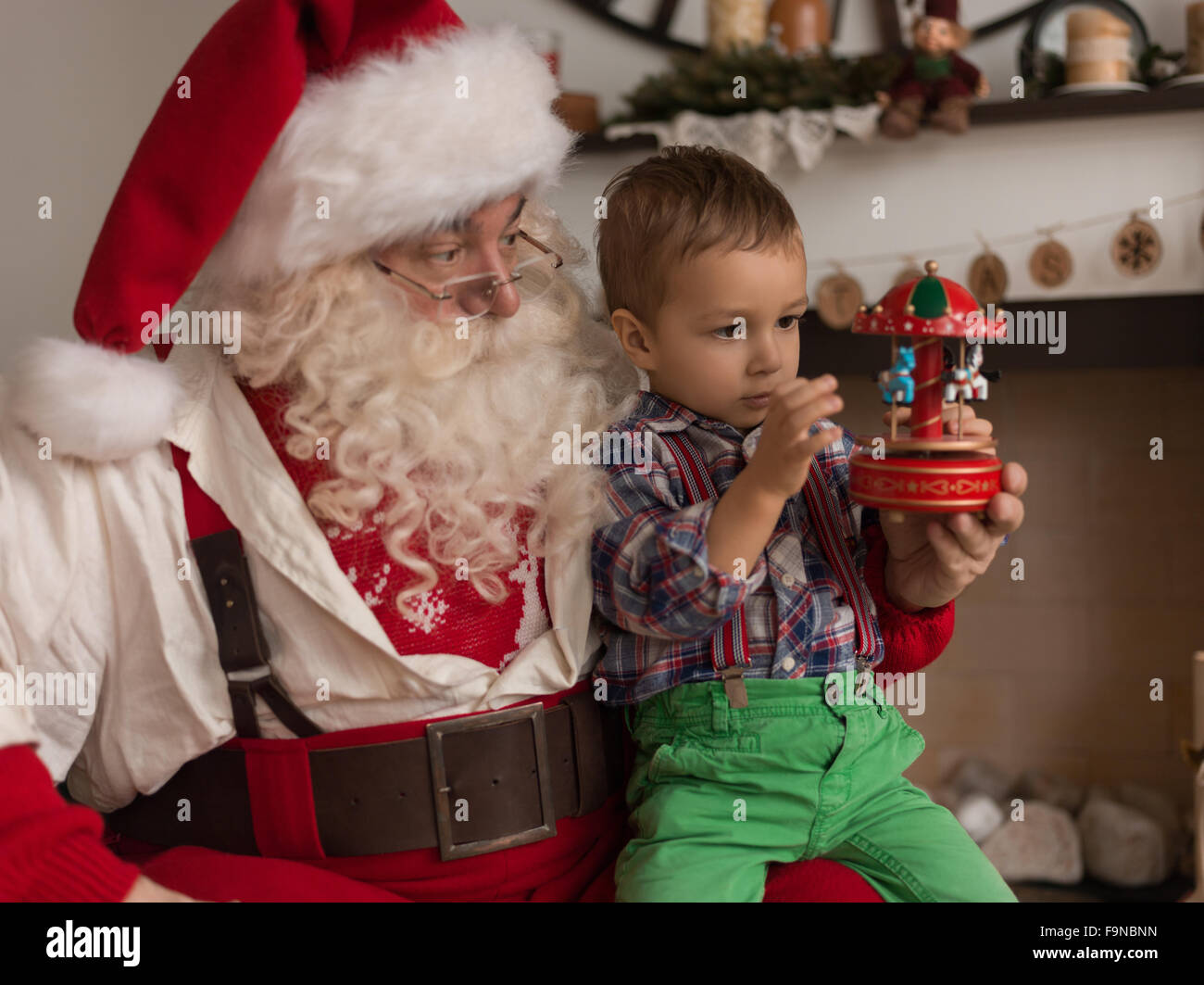Santa Claus with Child Playing Together at Home Stock Photo - Alamy