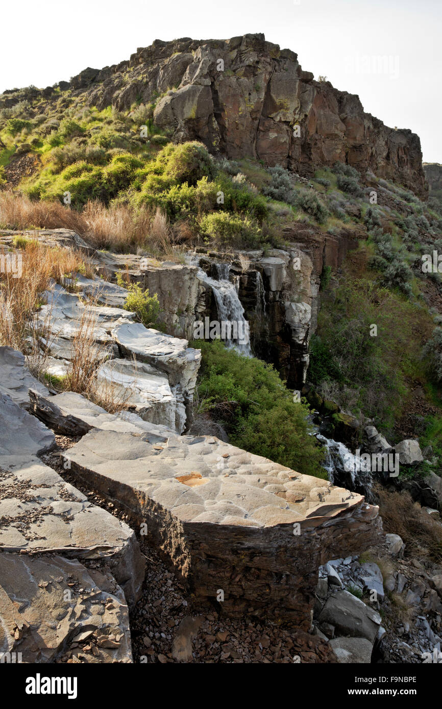 Sandstone among the columnar basalt bluffs and cliffs and a waterfall ...