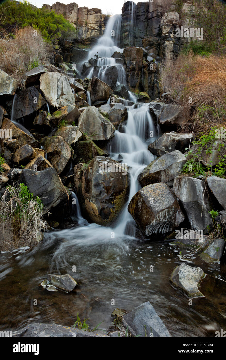 WASHINGTON - A waterfall descending over cliffs of columnar basalt to ...