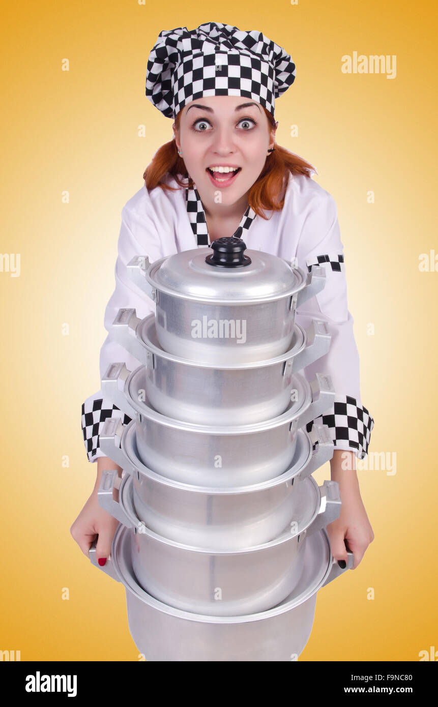 Cook with stack of pots on white Stock Photo - Alamy