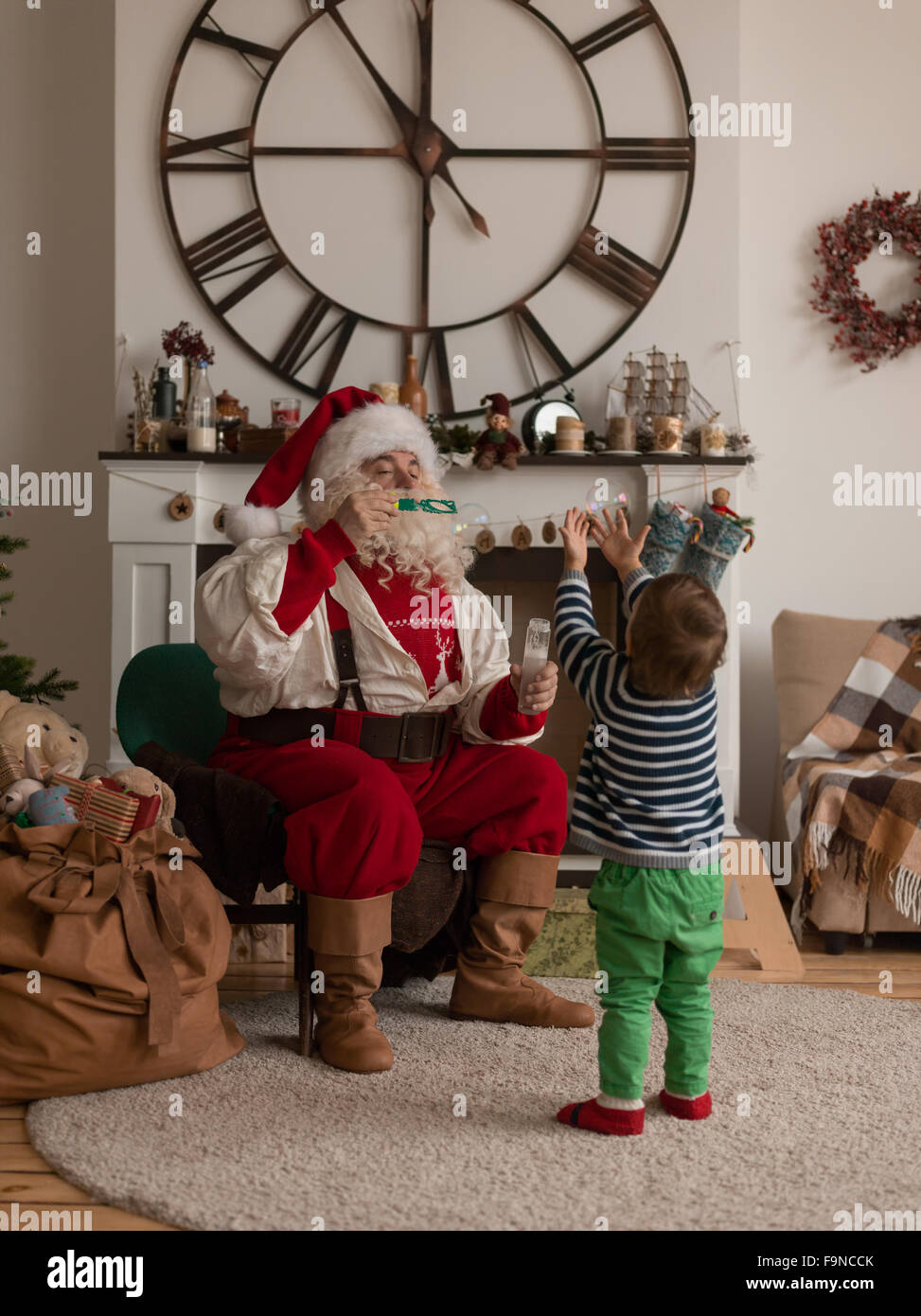 Santa Claus Playing at Home with Child Stock Photo - Alamy