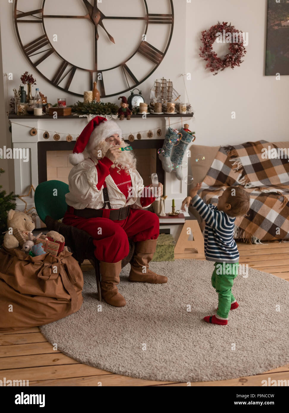 Santa Claus Playing at Home with Child Stock Photo - Alamy