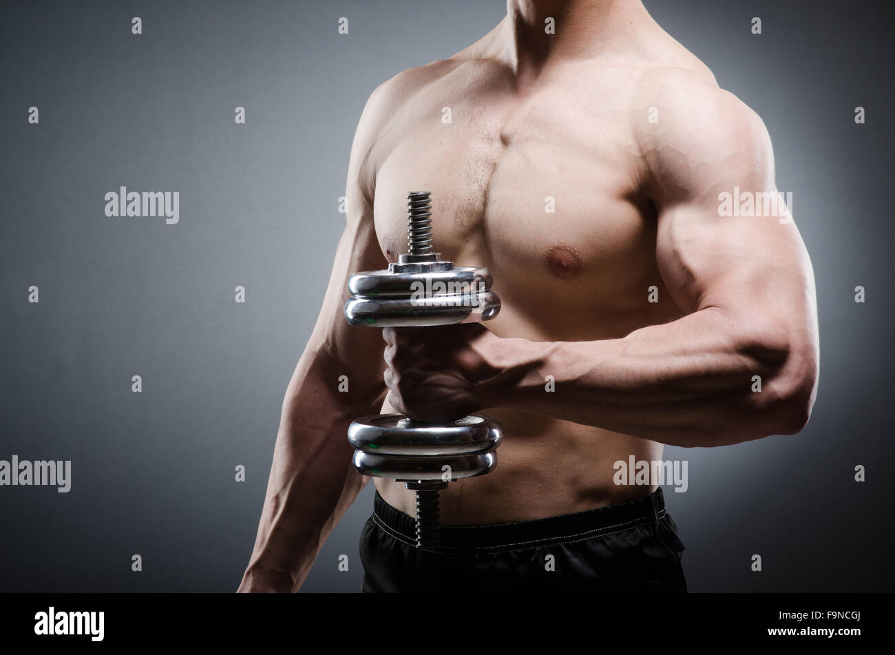 Muscular ripped bodybuilder with dumbbells Stock Photo - Alamy