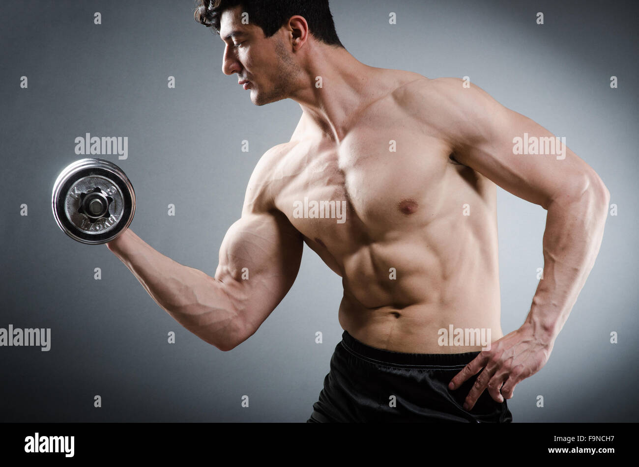 Muscular ripped bodybuilder with dumbbells Stock Photo - Alamy