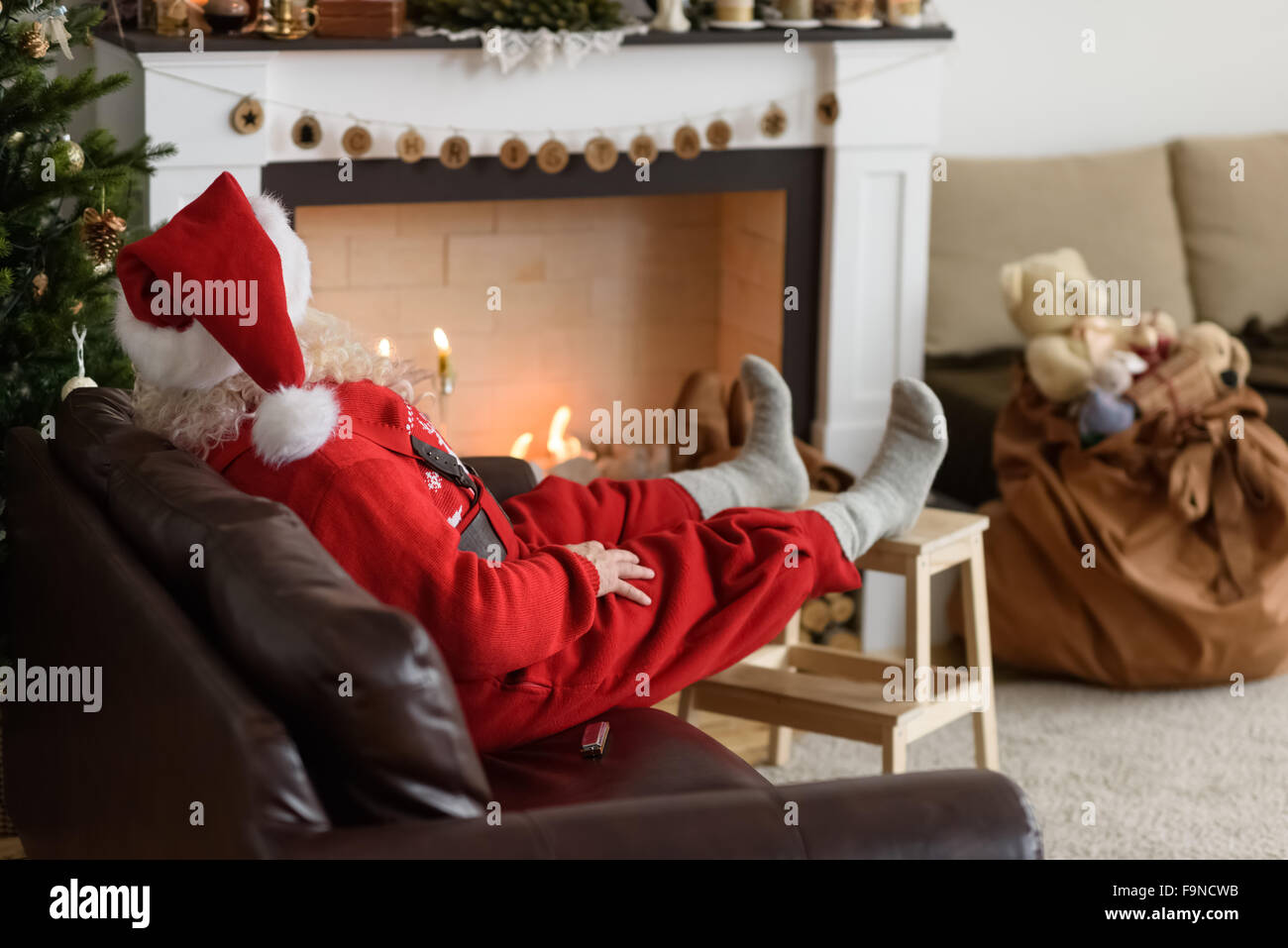 Santa Claus Warming near Fireplace at Home Stock Photo - Alamy