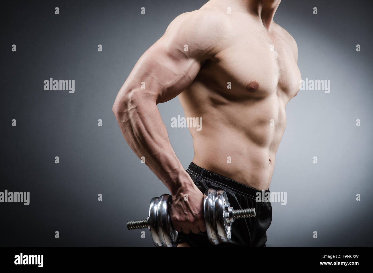 Muscular ripped bodybuilder with dumbbells Stock Photo - Alamy