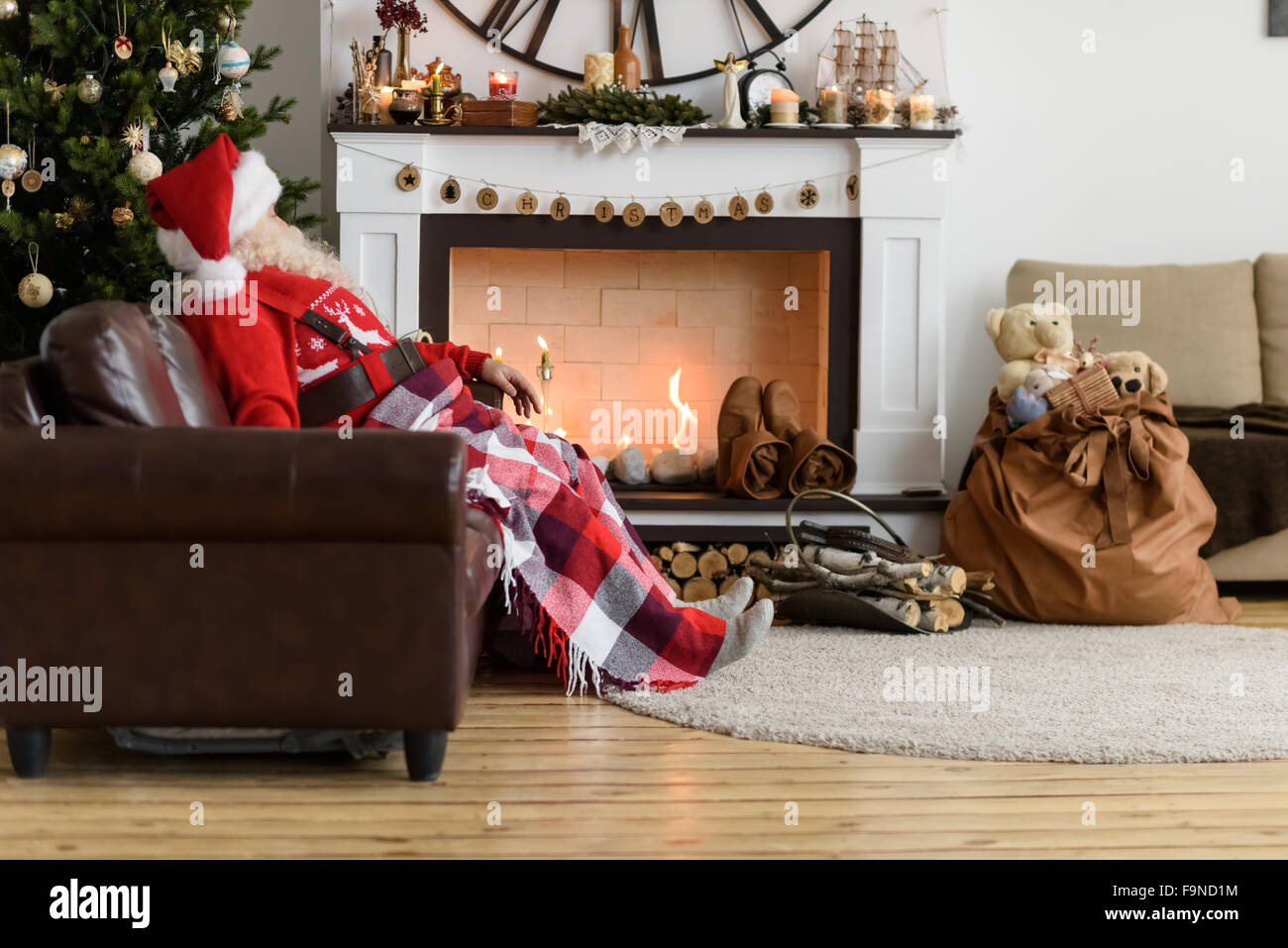 Santa Claus Warming near Fireplace at Home Stock Photo - Alamy