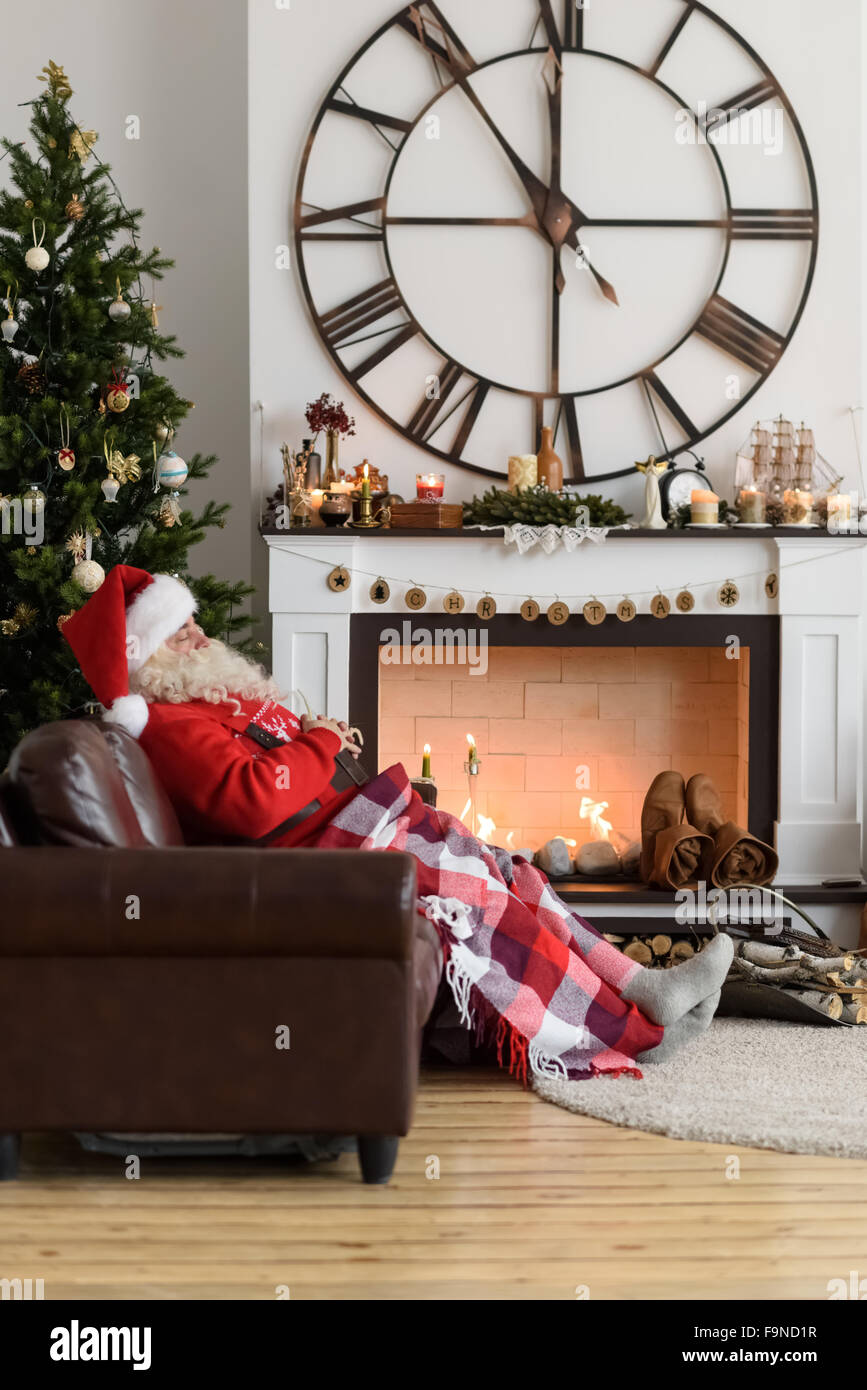 Santa Claus Warming near Fireplace at Home Stock Photo - Alamy