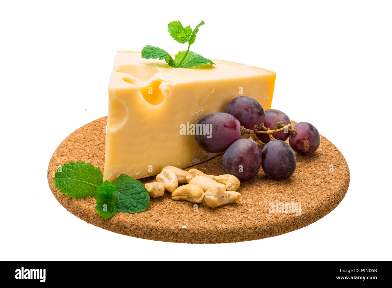 Yellow cheese with grape, mint and nuts Stock Photo - Alamy