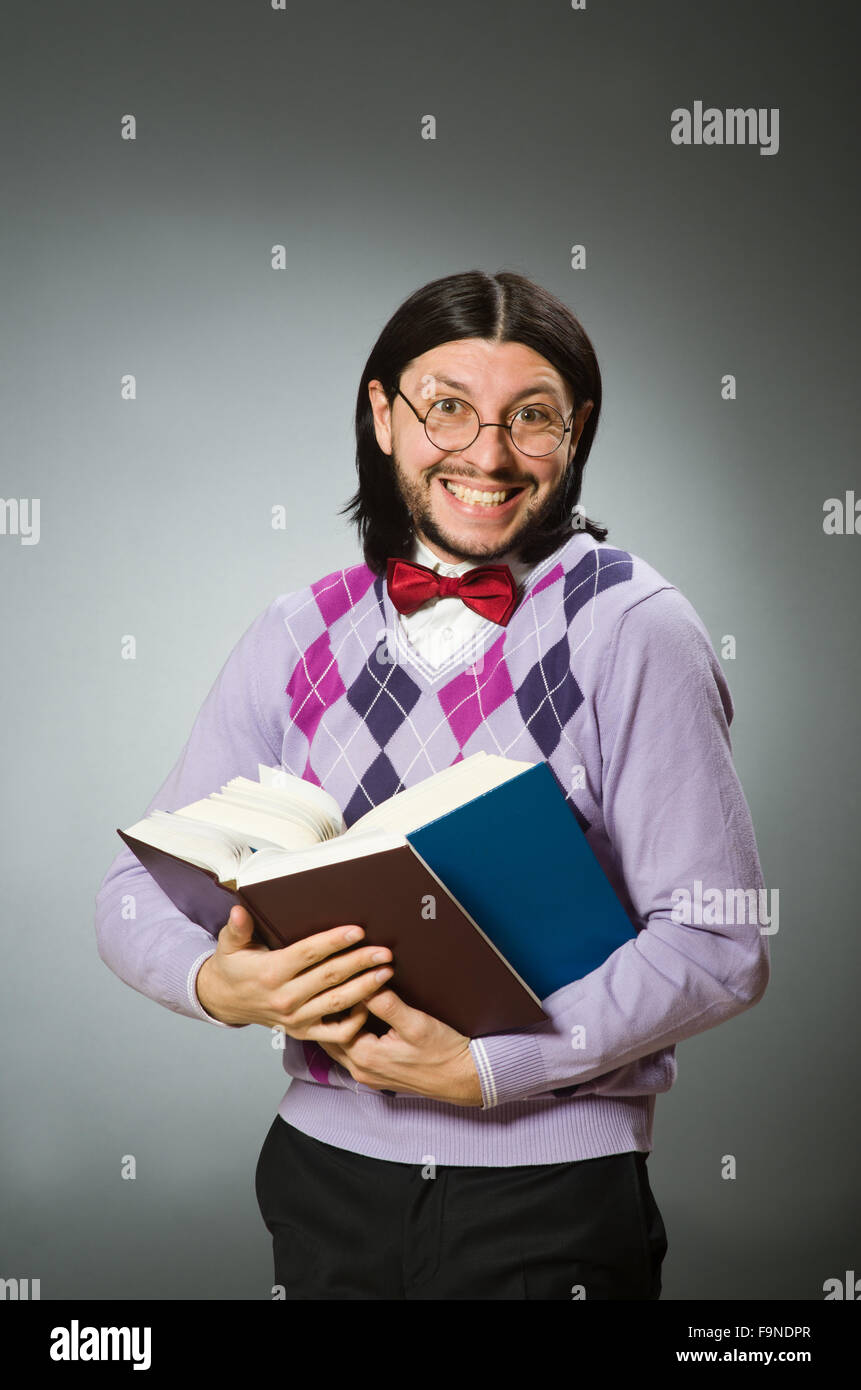 Young student with book in learning concept Stock Photo - Alamy