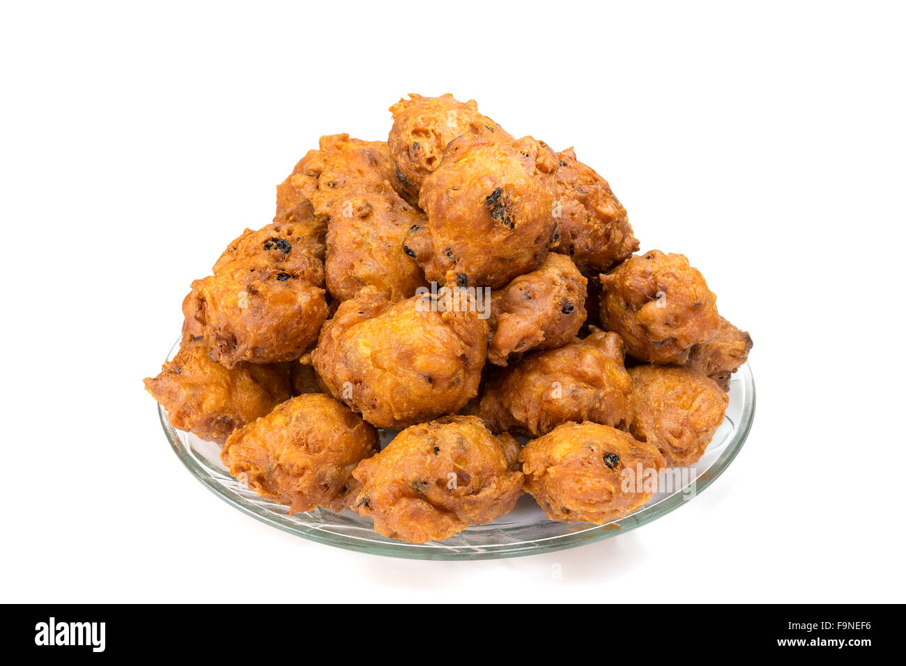 Heap of fried dutch fritters or oliebollen on scale isolated on white ...