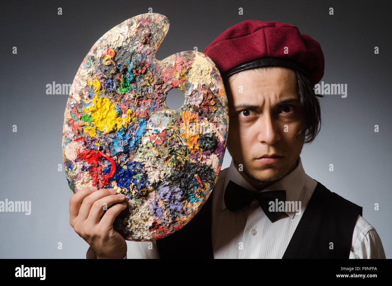 Funny artist in dark studio Stock Photo - Alamy