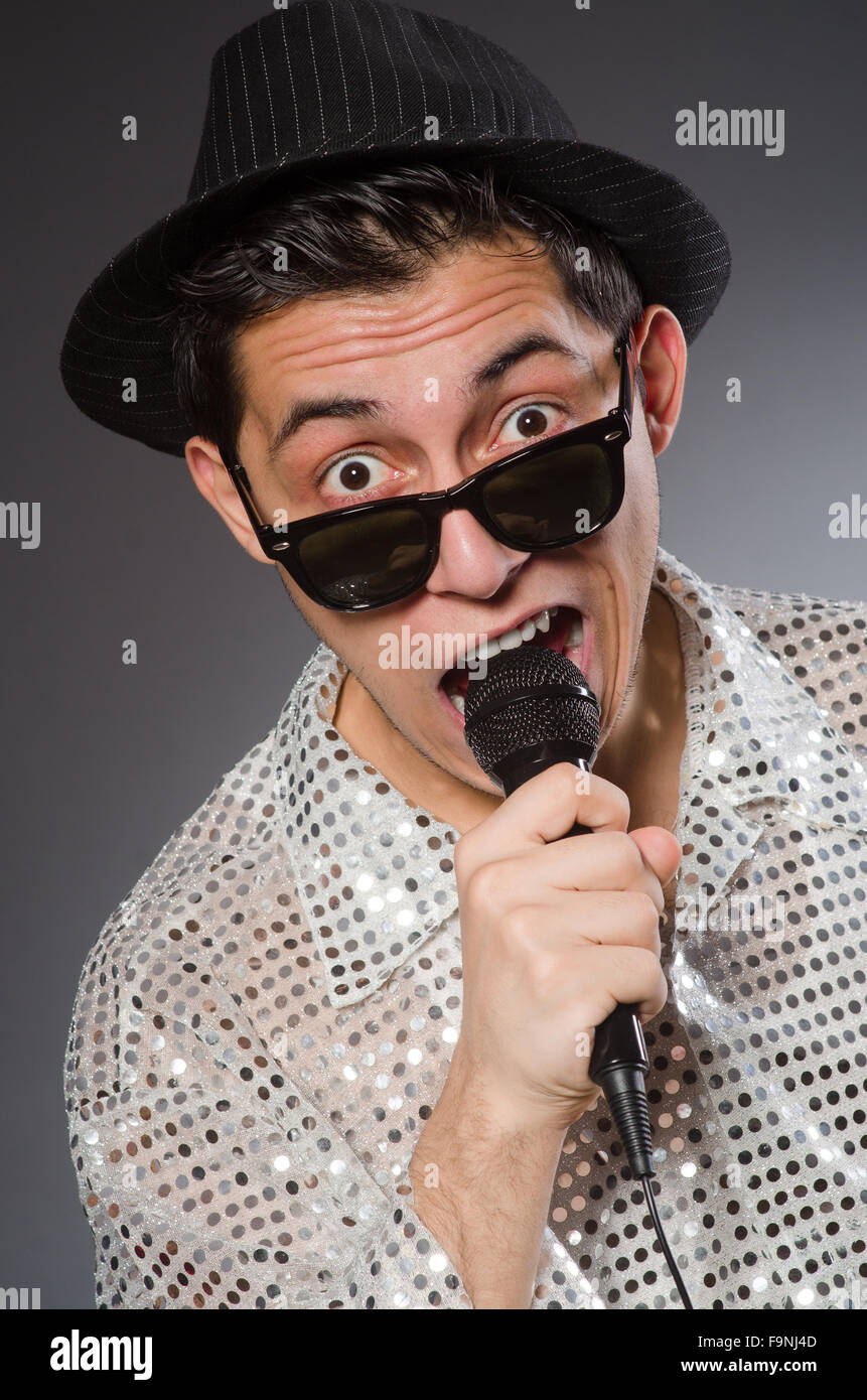 Young singer with microphone isolated on white Stock Photo - Alamy