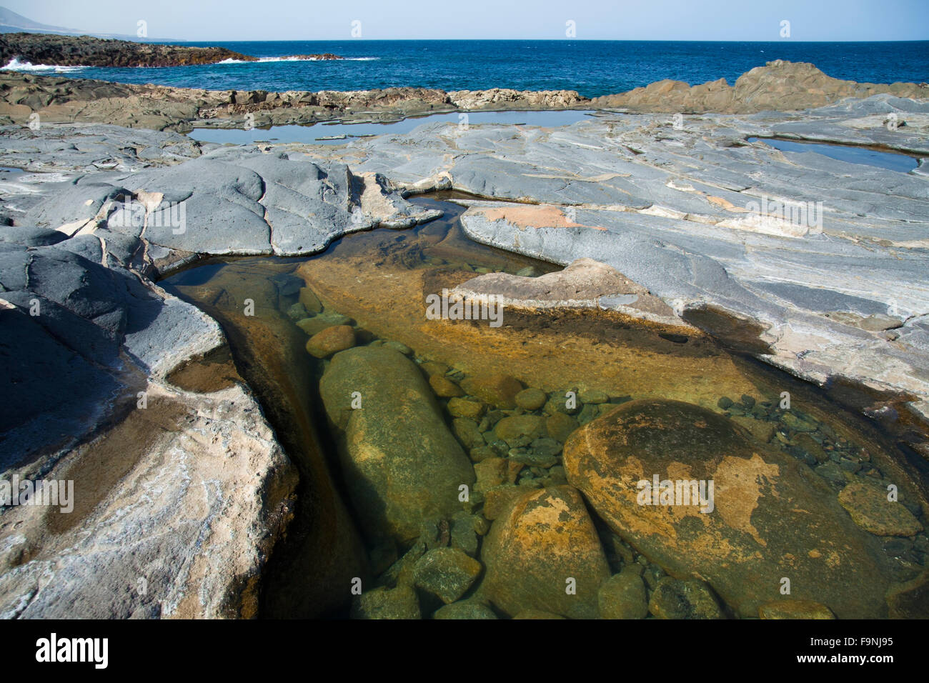 Gran Canaria, Banaderos area, calm rock pools, ocean at low tide Stock ...