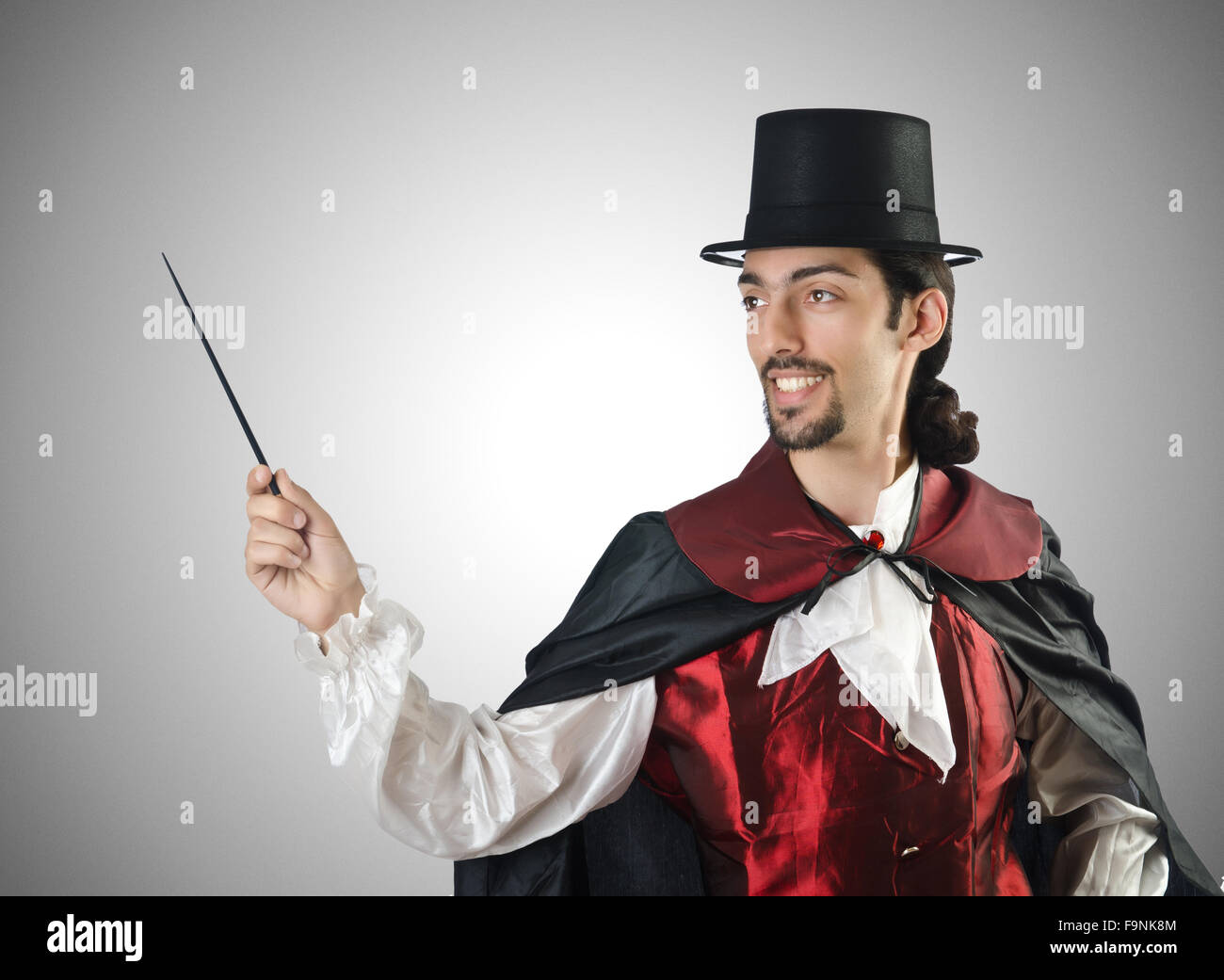 Magician doing tricks on white Stock Photo - Alamy