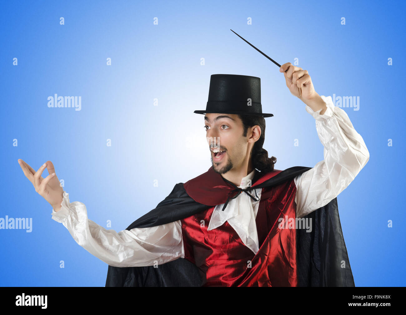 Magician doing tricks on white Stock Photo - Alamy