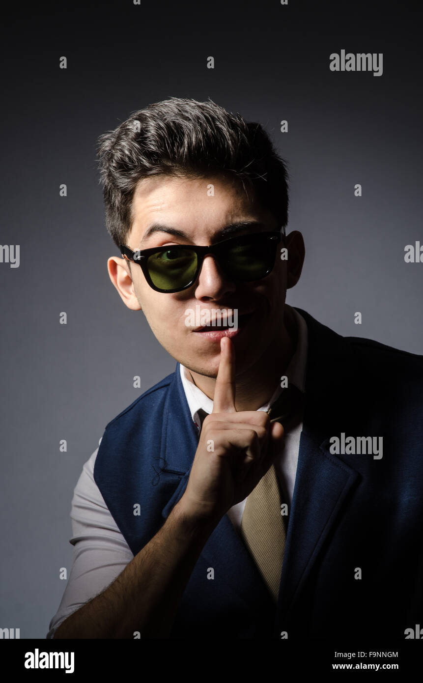 Young man in blue vest against gray Stock Photo - Alamy