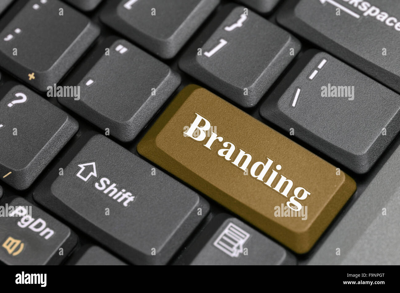 Brown branding key on keyboard Stock Photo - Alamy
