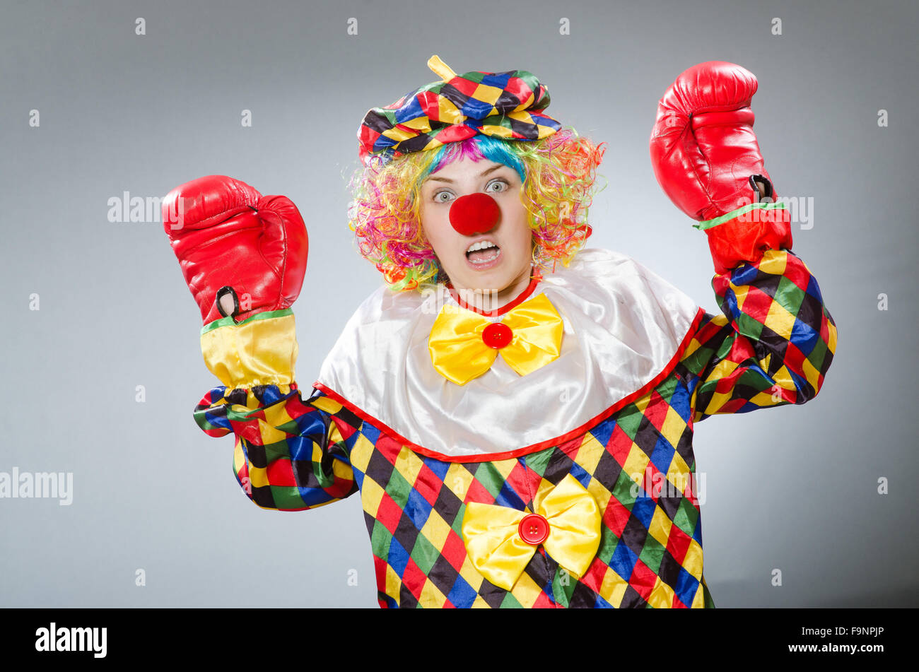 Clown with boxing gloves isolated on white Stock Photo - Alamy